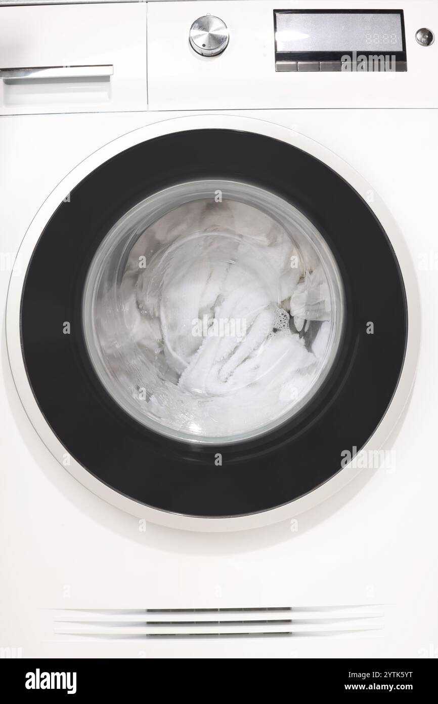 Washing machine with clothes as background, closeup Stock Photo - Alamy
