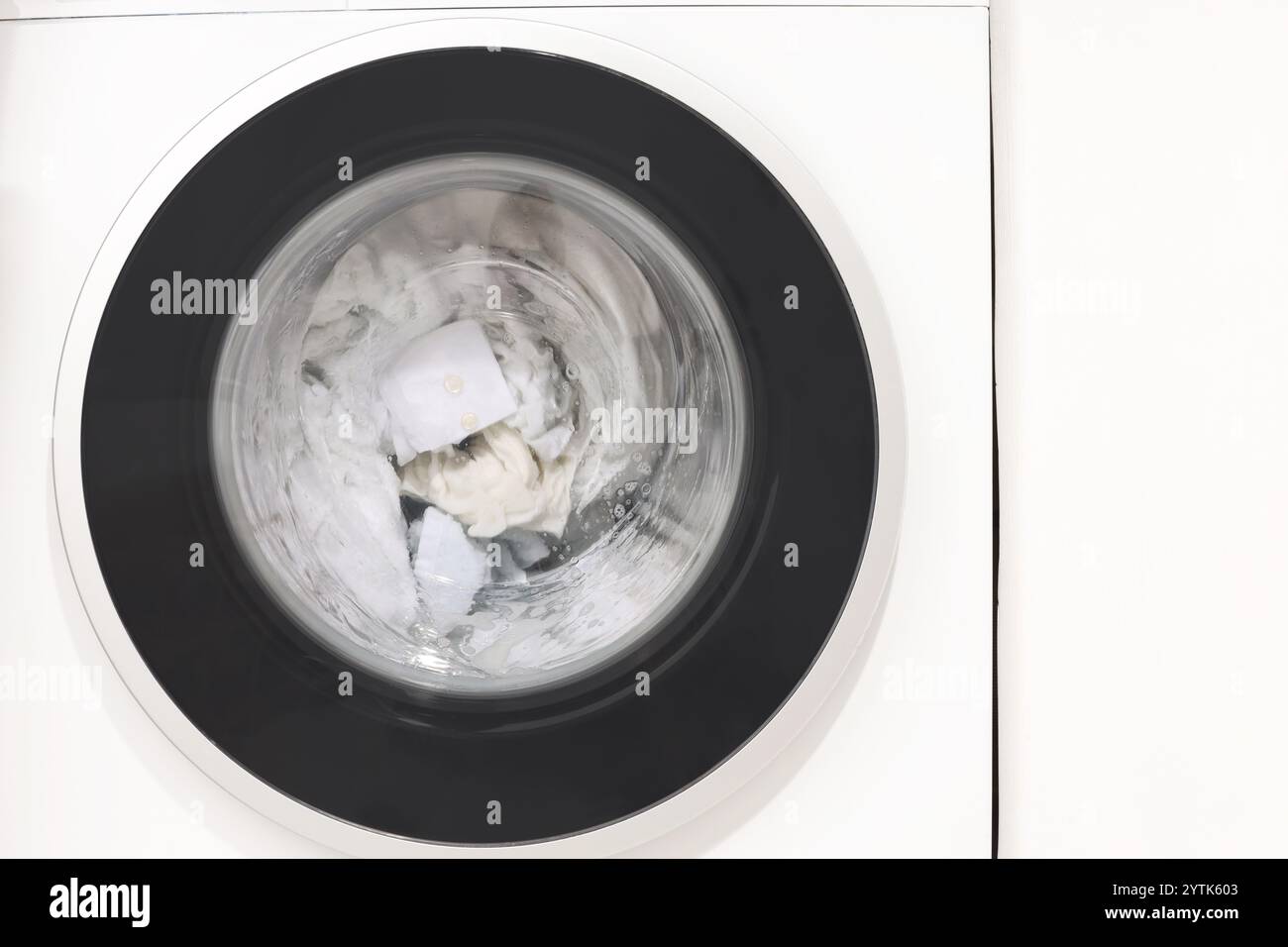 Washing machine with clothes as background, closeup Stock Photo - Alamy