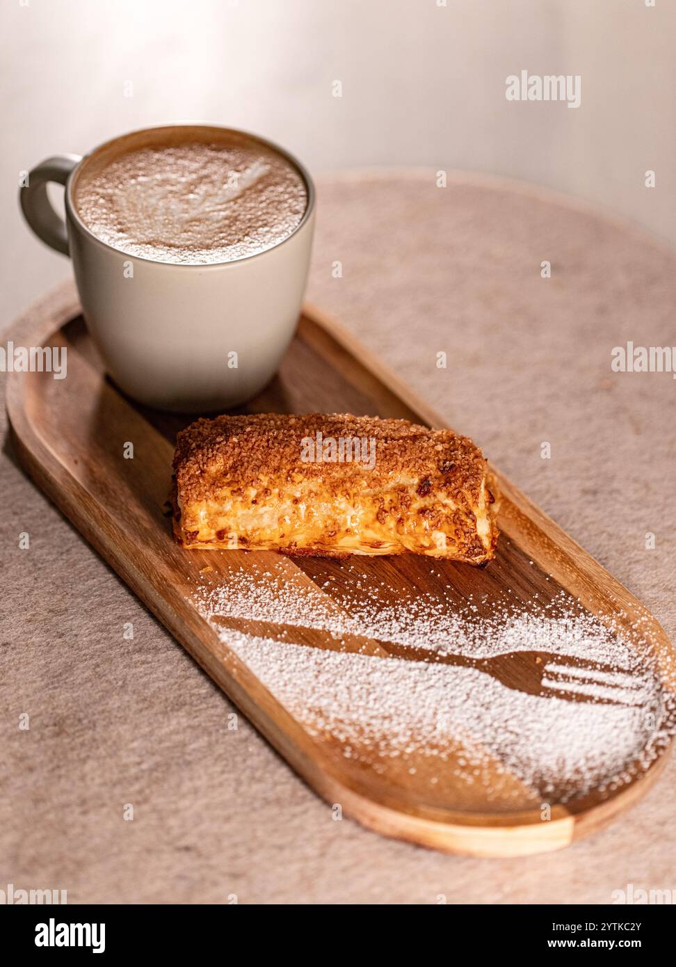 Delicious crunchy pastry and cappuccino resting on wooden tray ...