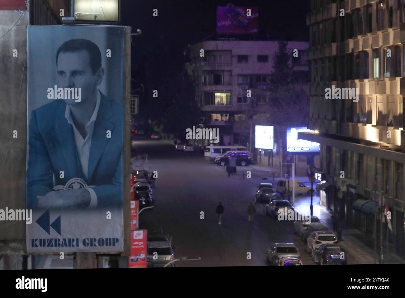 A giant banner of Syrian President Bashar Assad hangs on the facade of ...