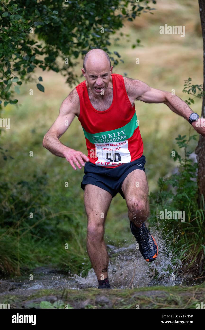 Runners on the Kilnsey Crag fell race held at the Kilnsey Show in the ...