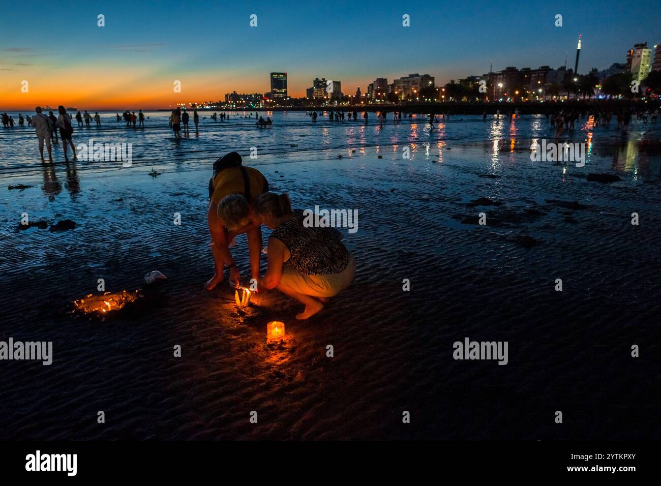 Worshipers light candles to pay tribute to Yemanjá, the African ...