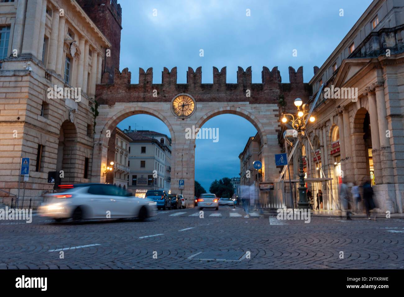 VERONA, ITALY - OCTOBER 25, 2023: Medieval city walls and clock on the ...