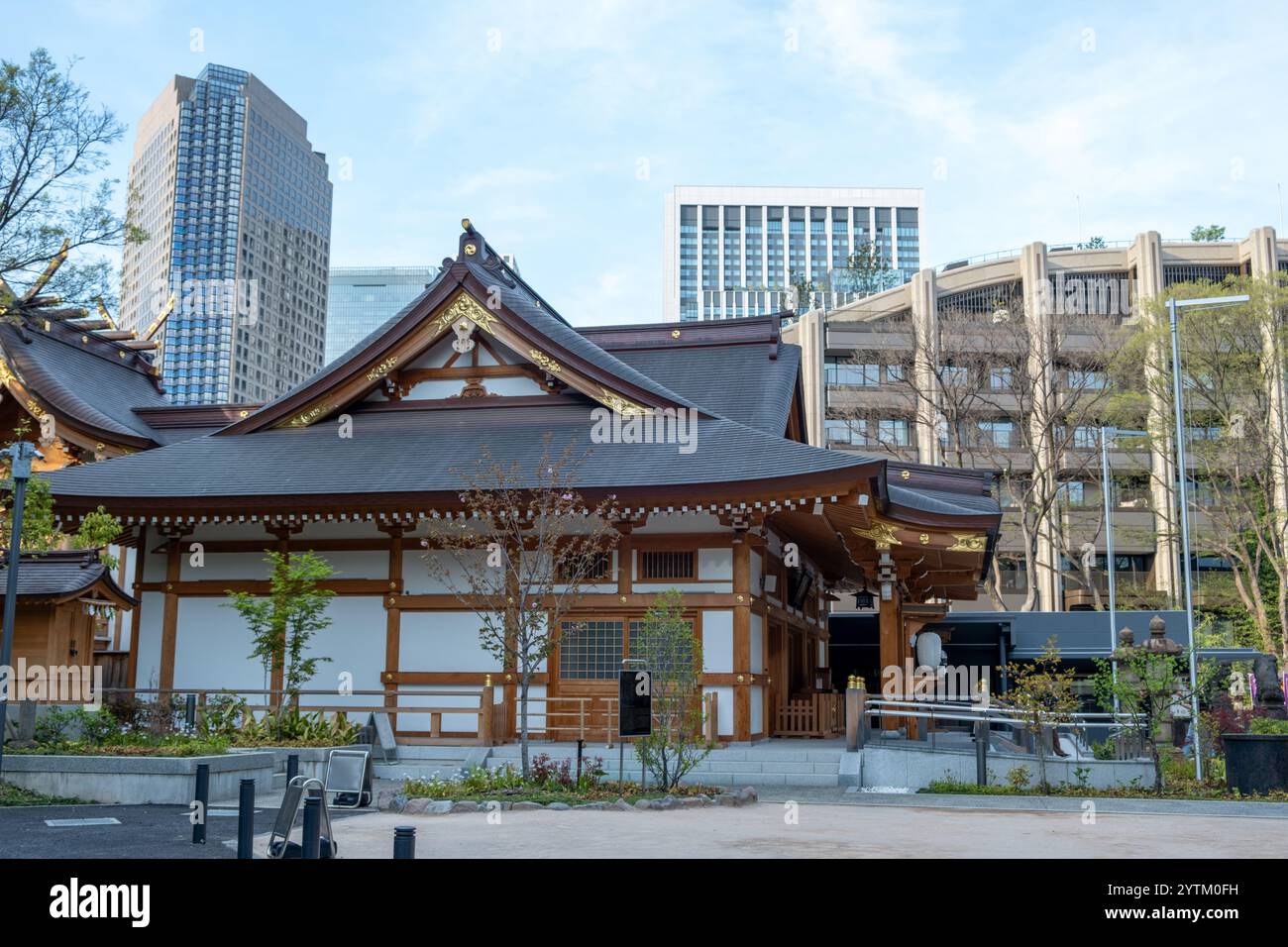 Traditional Shinto shrine against the modern urban backdrop of Tokyo ...