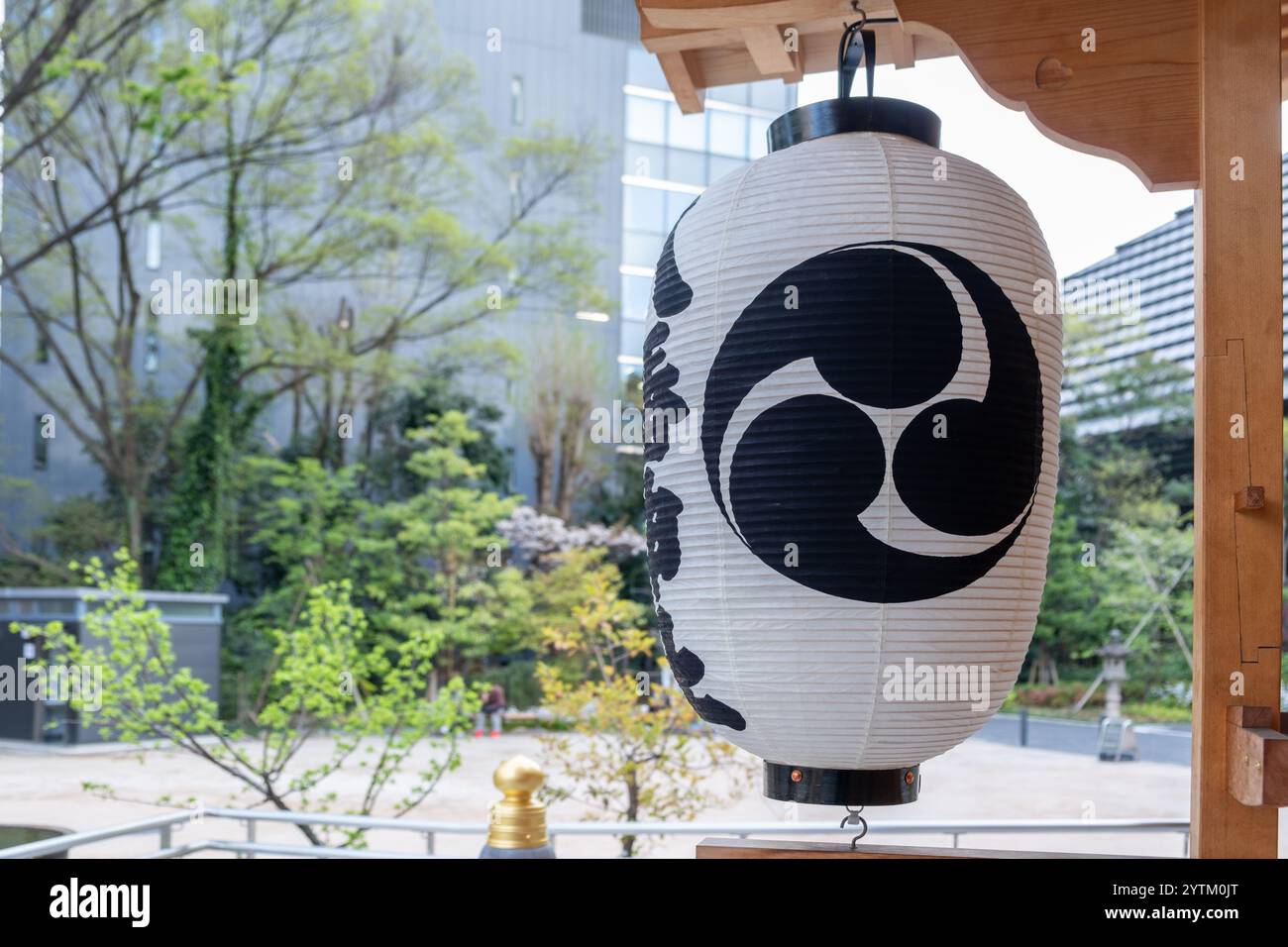Traditional Japanese paper lantern hanging from a wooden structure ...