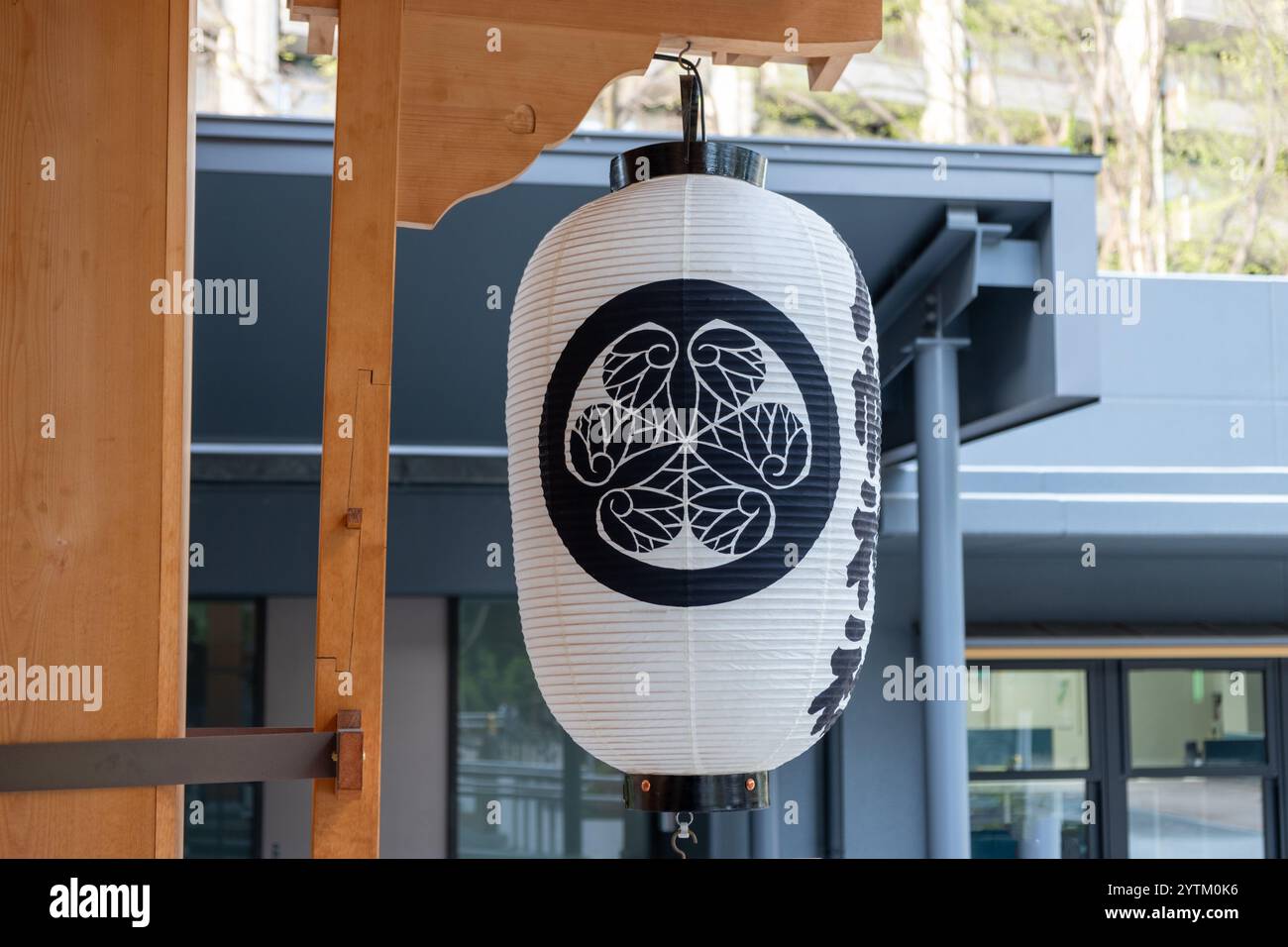 Traditional Japanese paper lantern hanging from a wooden structure ...
