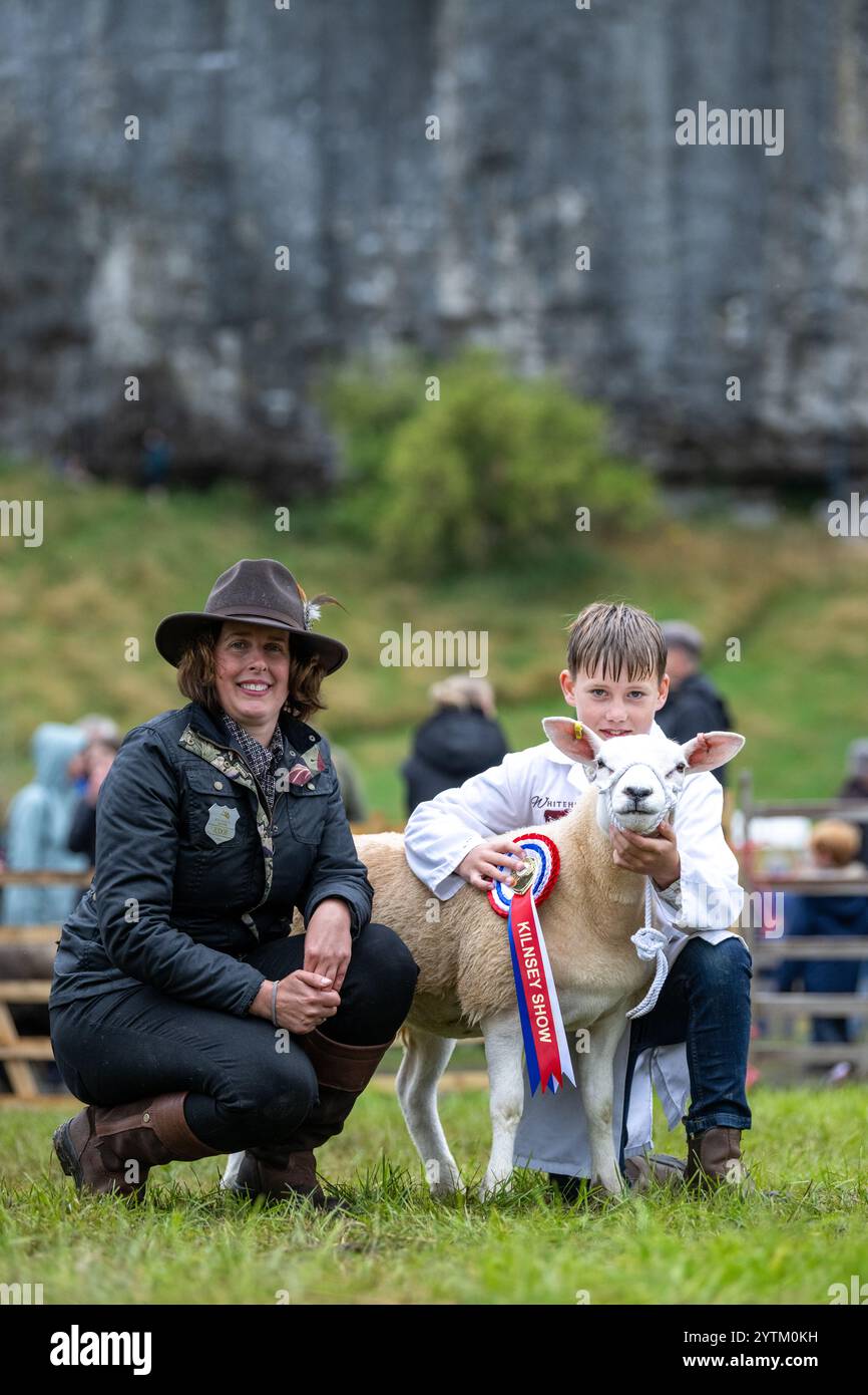 Sheep being shown at the 2024 Kilnsey Show under the shadow of Kilnsey ...