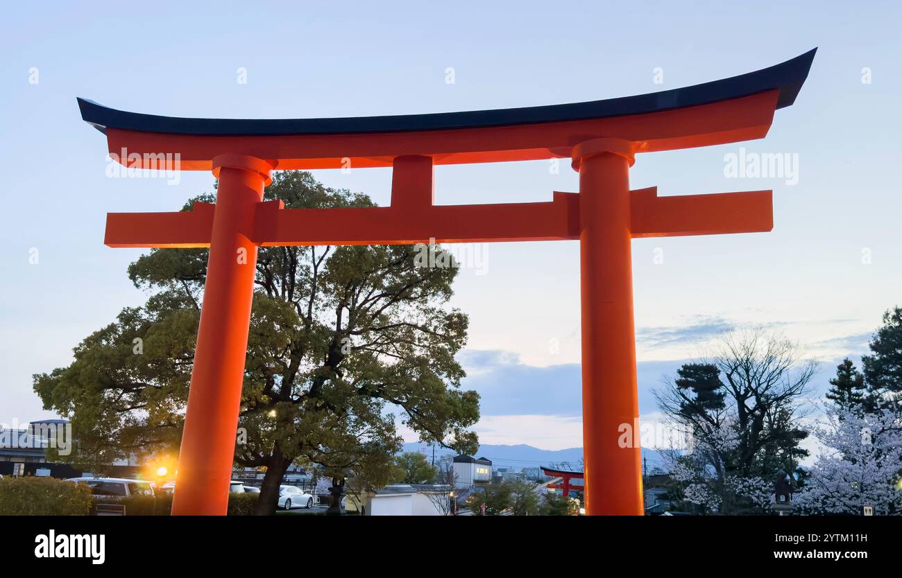 Torii gate in the entrance of Fushimi Inari taisha Grand Shrine at dusk ...