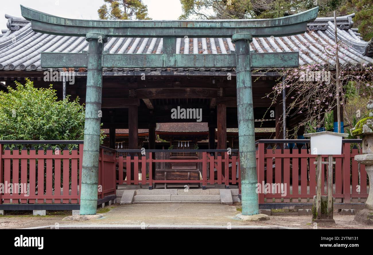 Japanese temple entrance with a traditional torii gate, Japan. Tiled ...