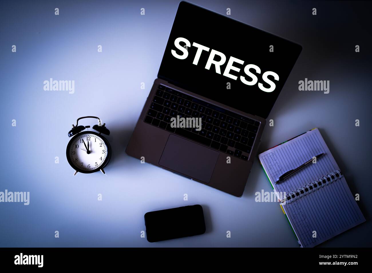 Word stress on the laptop screen, notes and a clock on a office desk ...