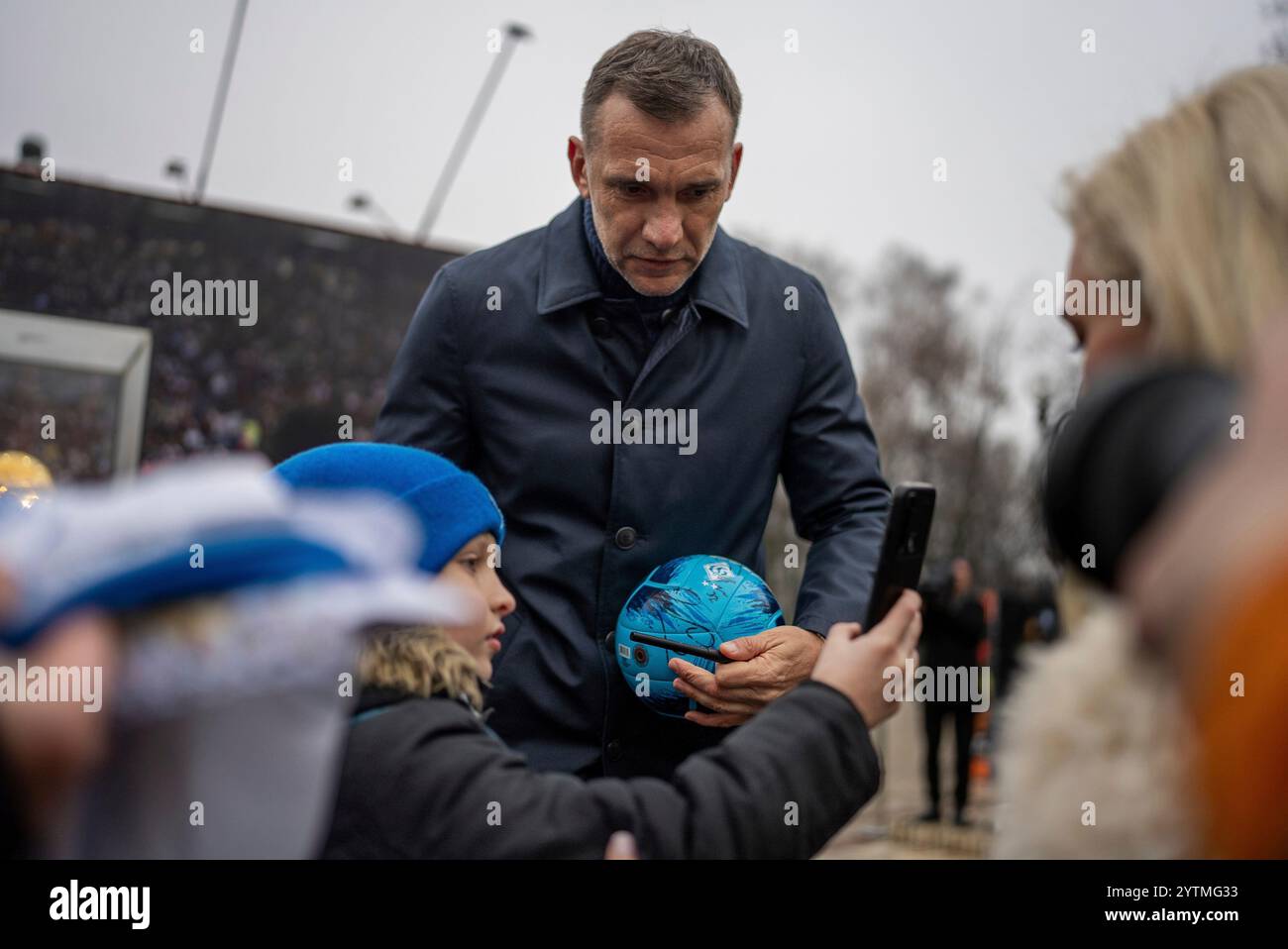 Ukrainian soccer legend Andriy Shevchenko poses for a photo with a fan ...