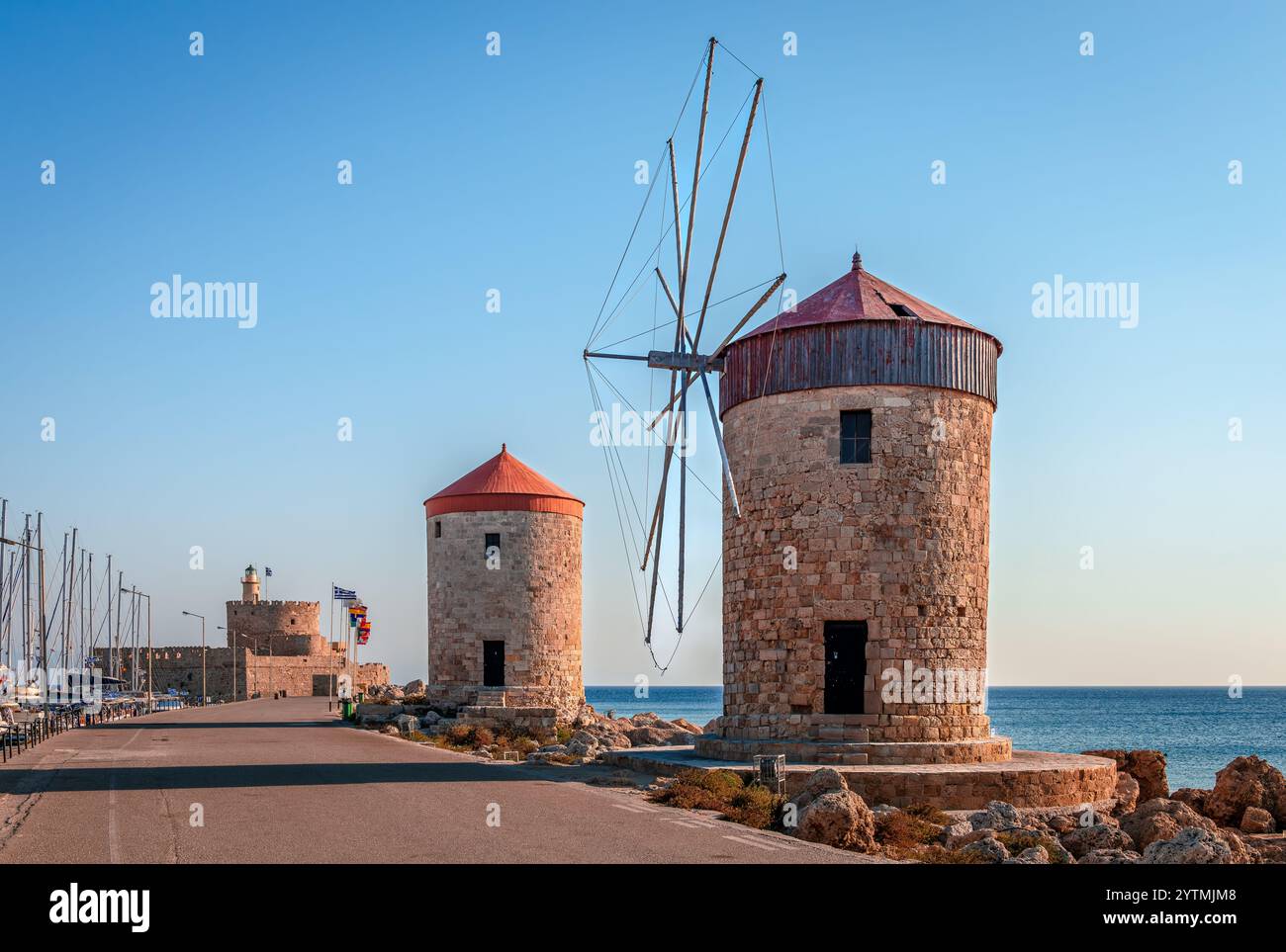 The medieval windmills on the wave breaker at Mandraki harbour, Rhodes ...