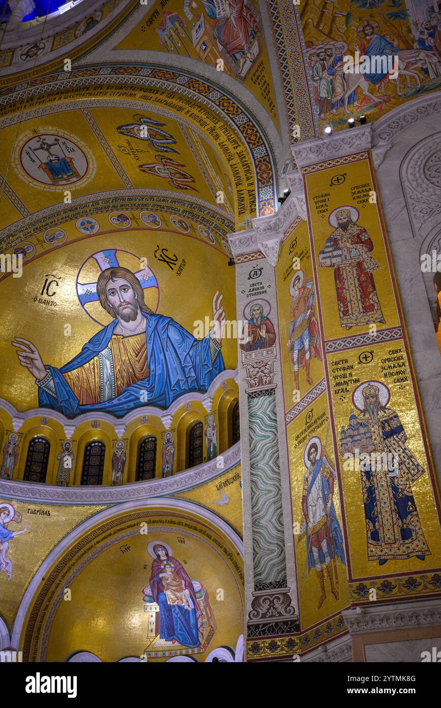 Ornate interior of the Church of Saint Sava decorated with frescoes and golden mosaics, Serbian ...