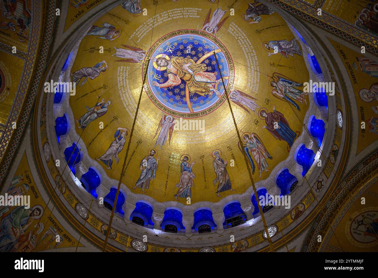 Ornate interior of the Church of Saint Sava decorated with frescoes and golden mosaics, Serbian ...