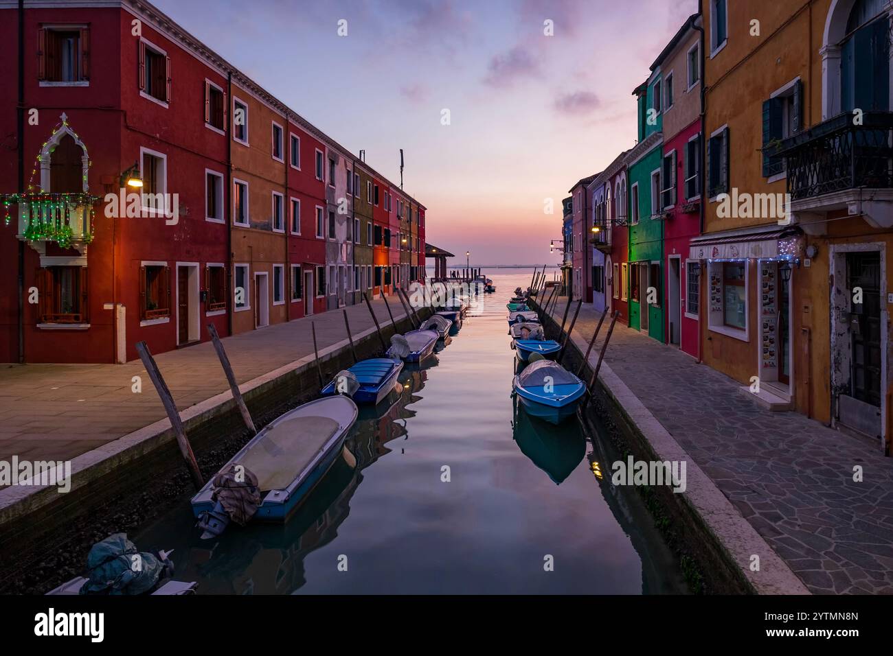 Traditional houses next to a canal in Burano an island in the Lagoon of ...
