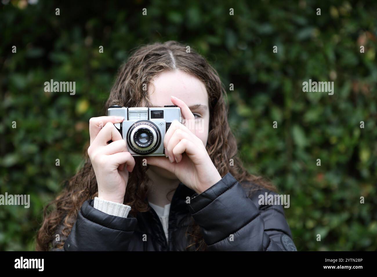 Film camera teenage girl using a 35mm film camera analogue retro camera ...