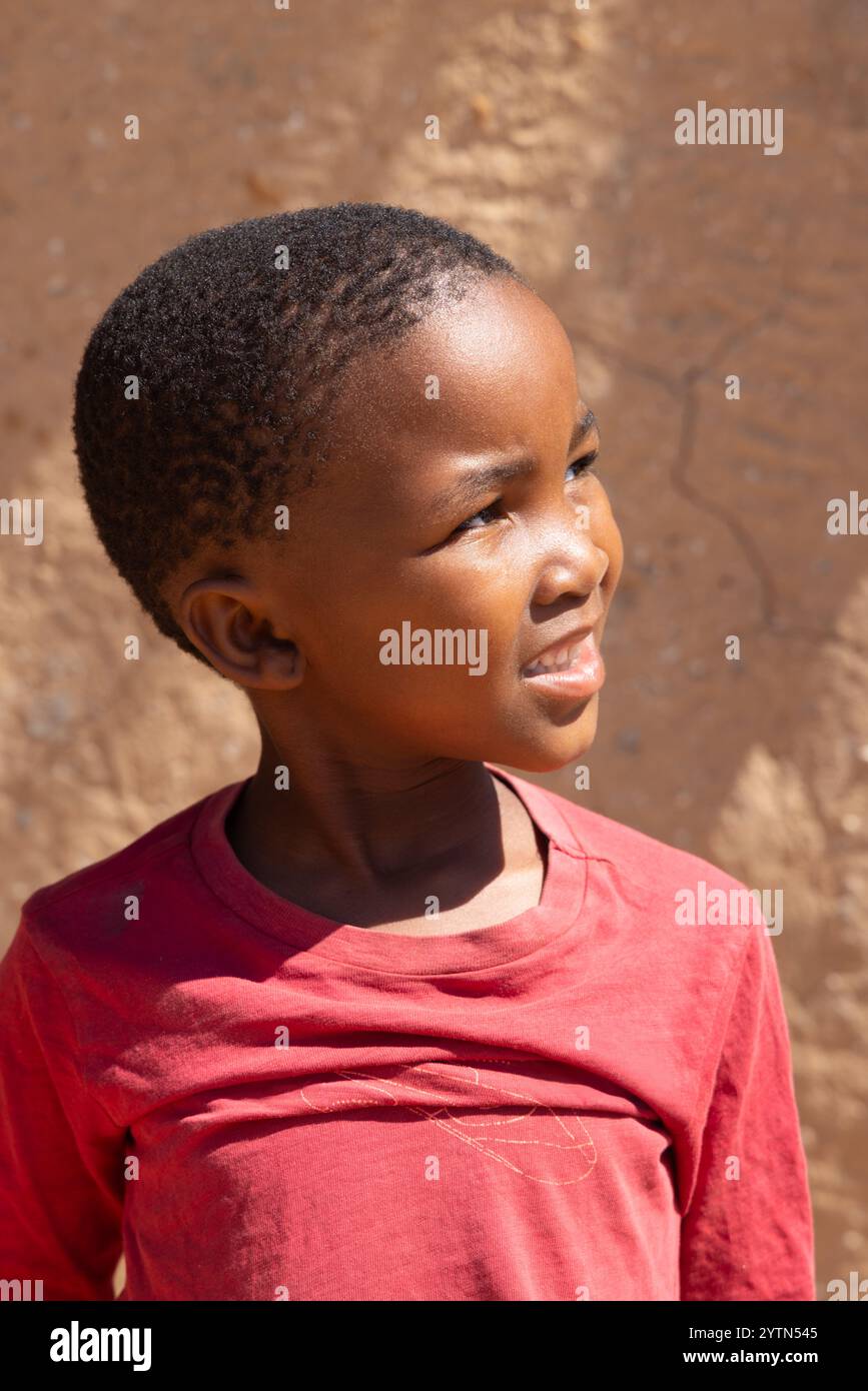 african village, young girl child looking up, half portrait head and ...