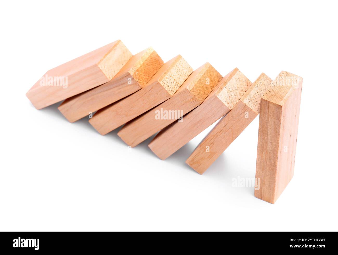 Domino effect. Wooden blocks falling on white background Stock Photo ...