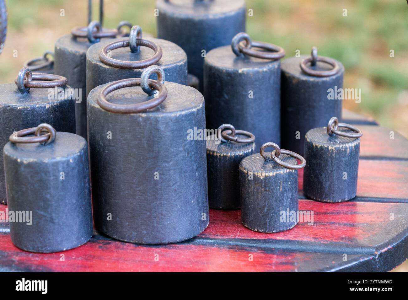 Old metal weights on a balance scale on a wooden tray Stock Photo - Alamy