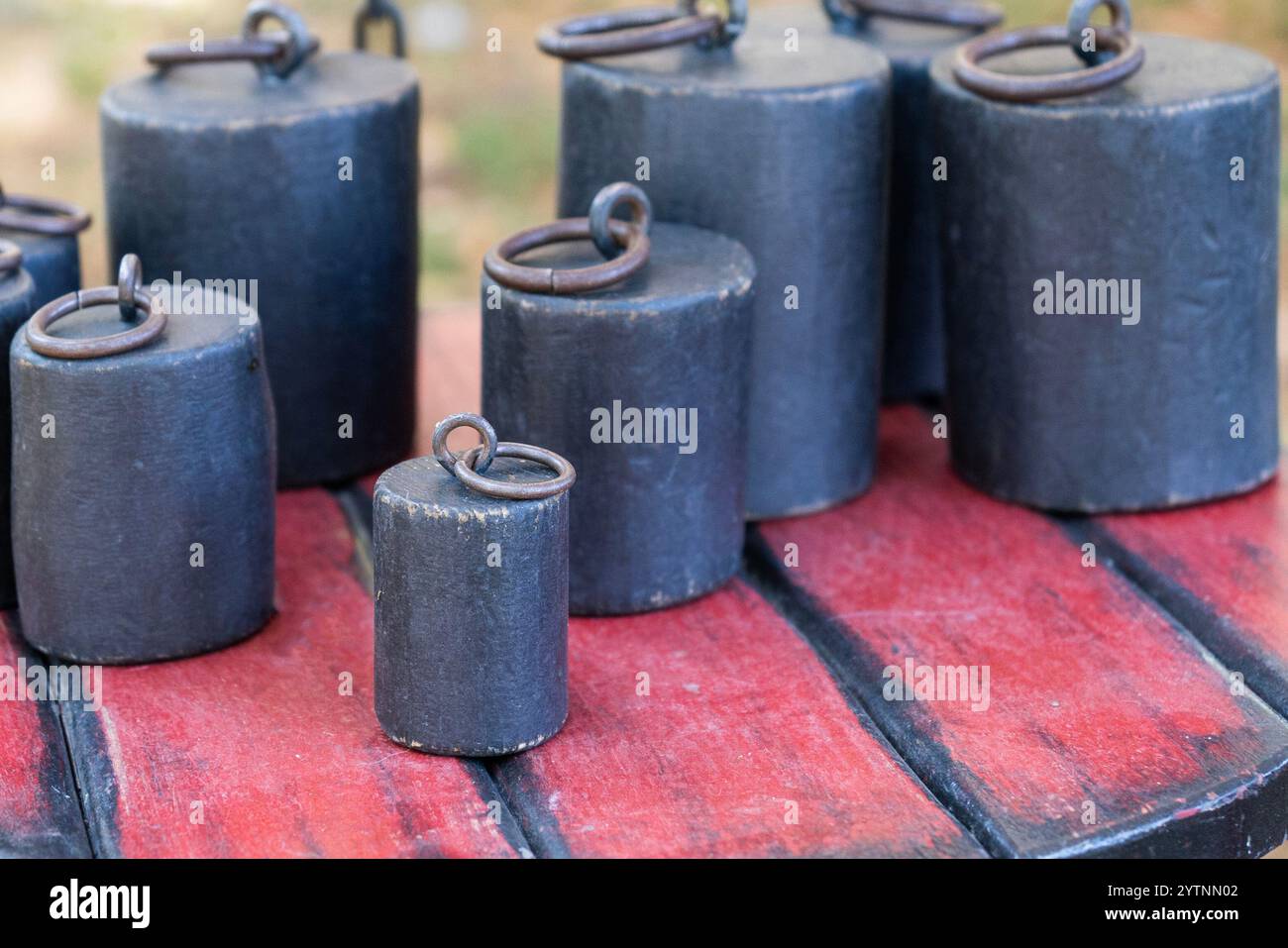Old metal weights on a balance scale on a wooden tray Stock Photo - Alamy