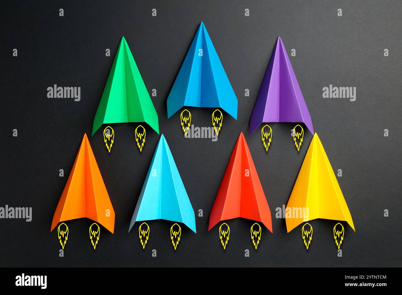 Colorful paper planes rushing forward on black background Stock Photo ...