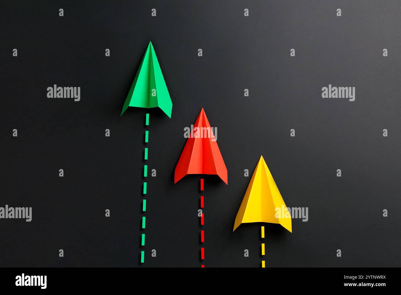 Colorful paper planes with flight paths on black background. Dashed ...