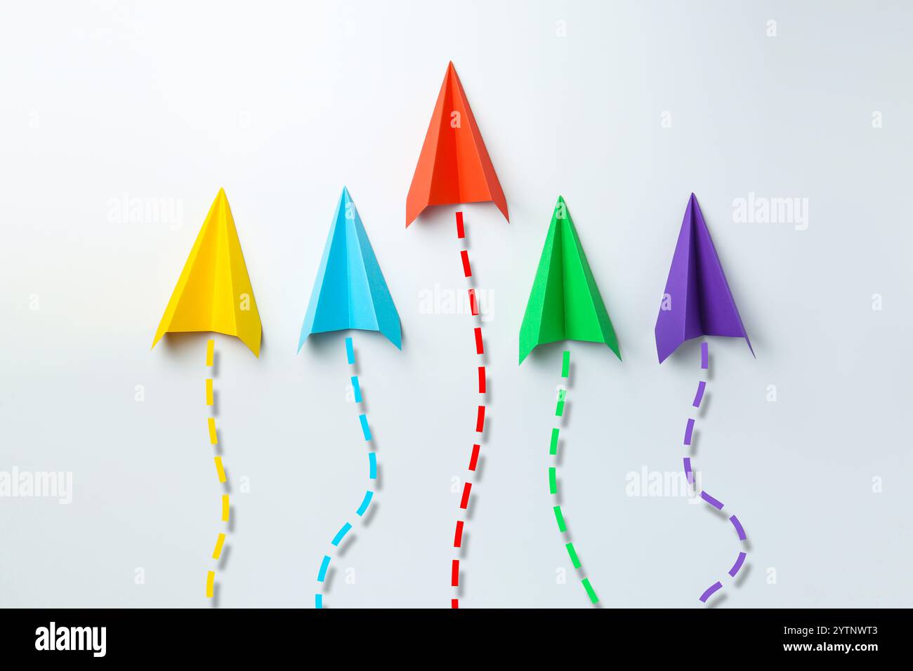 Colorful paper planes with flight paths on white background. Dashed ...