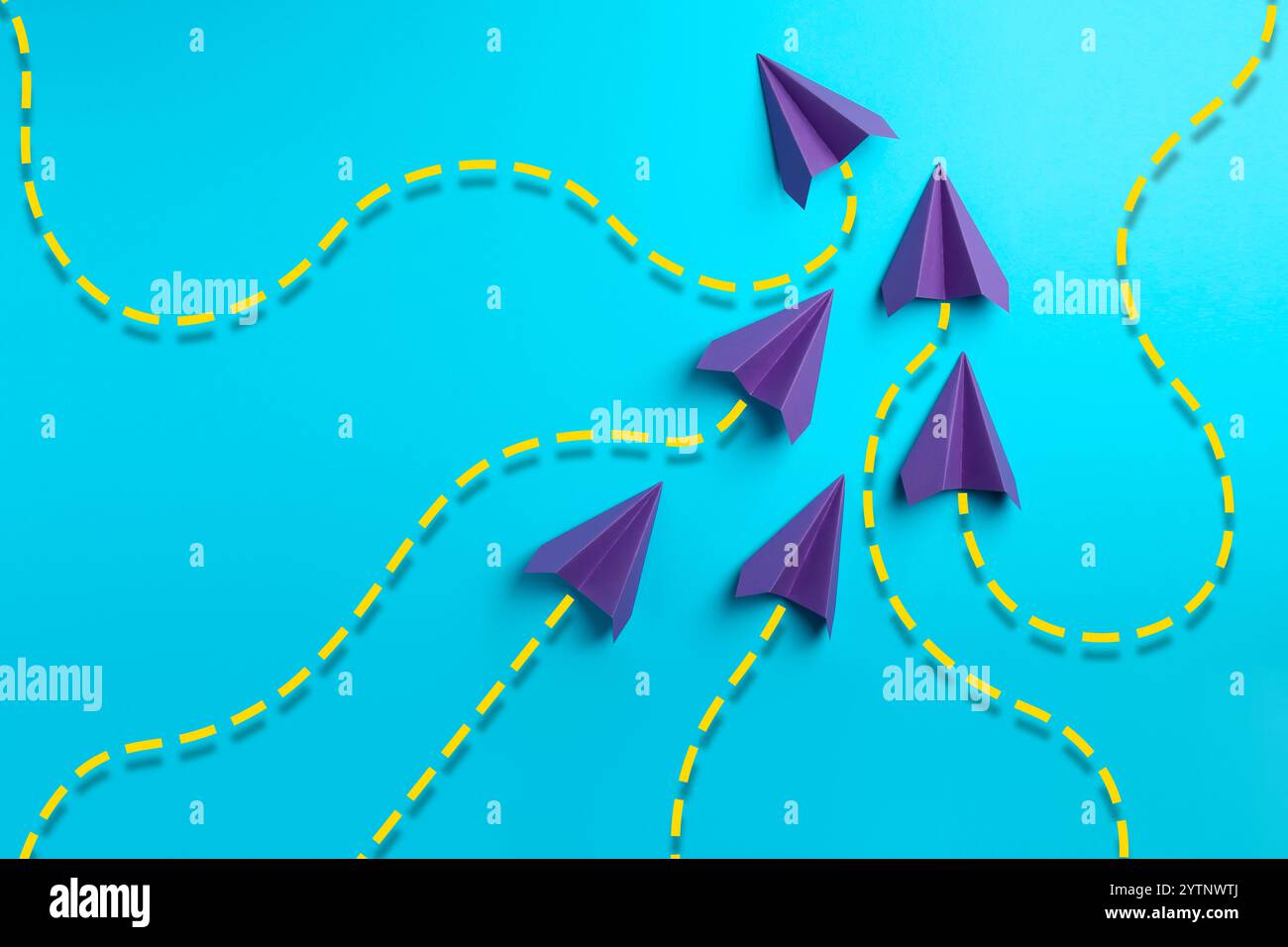 Purple paper planes with flight paths on light blue background. Dashed ...