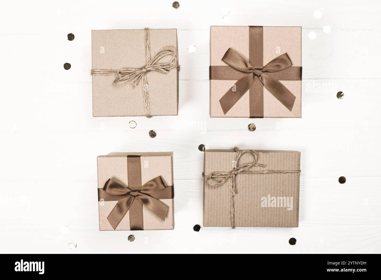 Four beautifully wrapped gift boxes with ribbons and natural twine ...