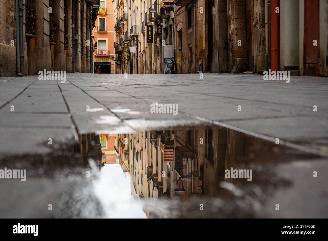 Reflections in puddles following rainfall during Santa Tecla festival ...