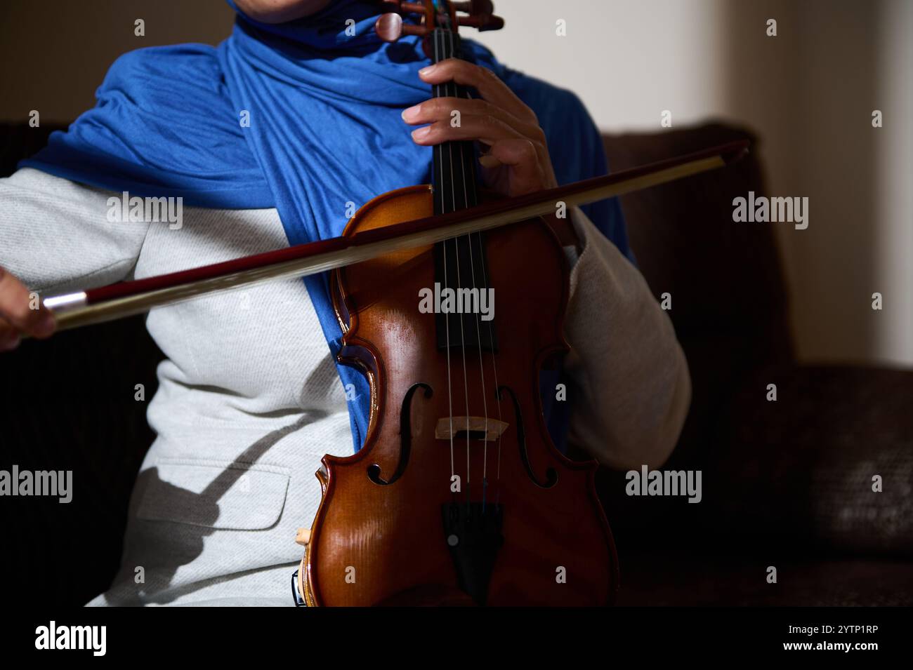 A detailed shot of someone playing a violin, emphasizing musical ...