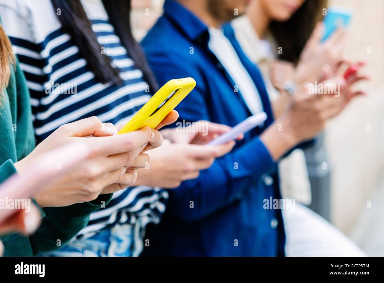 Young people using mobile phones outdoors, social media and technology ...