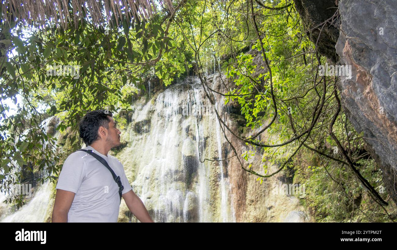A visitor admires the picturesque waterfalls at Pozas Azules in Atzala ...