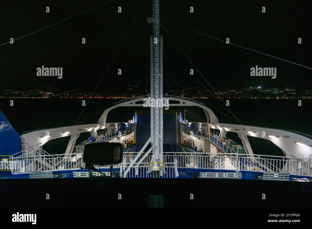 Car ferry crossing the street of Messina with view at the illuminated ...
