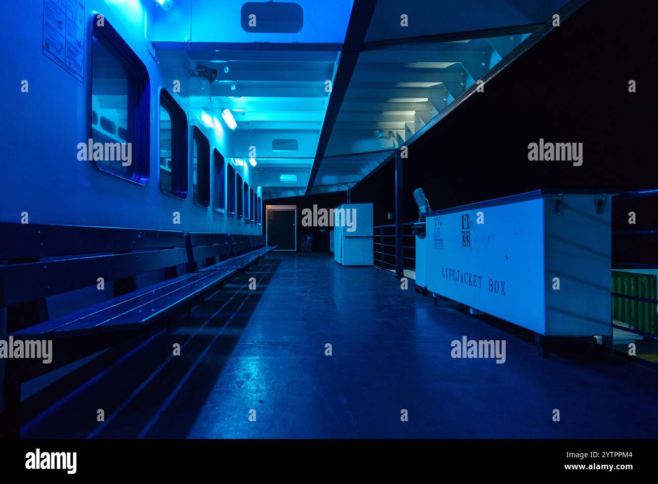 Illuminated deck of car ferry boat with bench during nighttime in the ...
