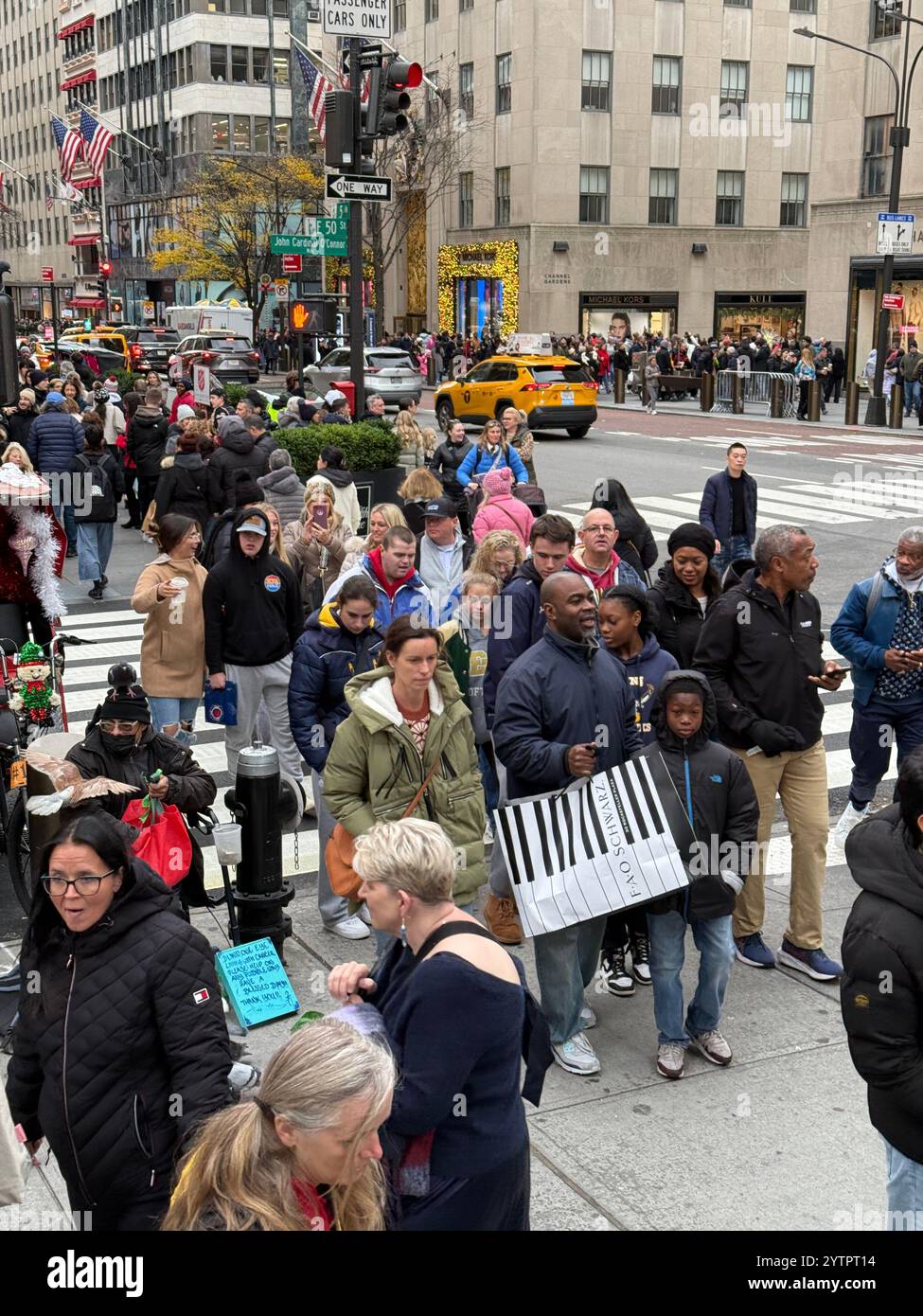 Family walks on 5th Avenue on Black Friday doing some holiday shopping ...