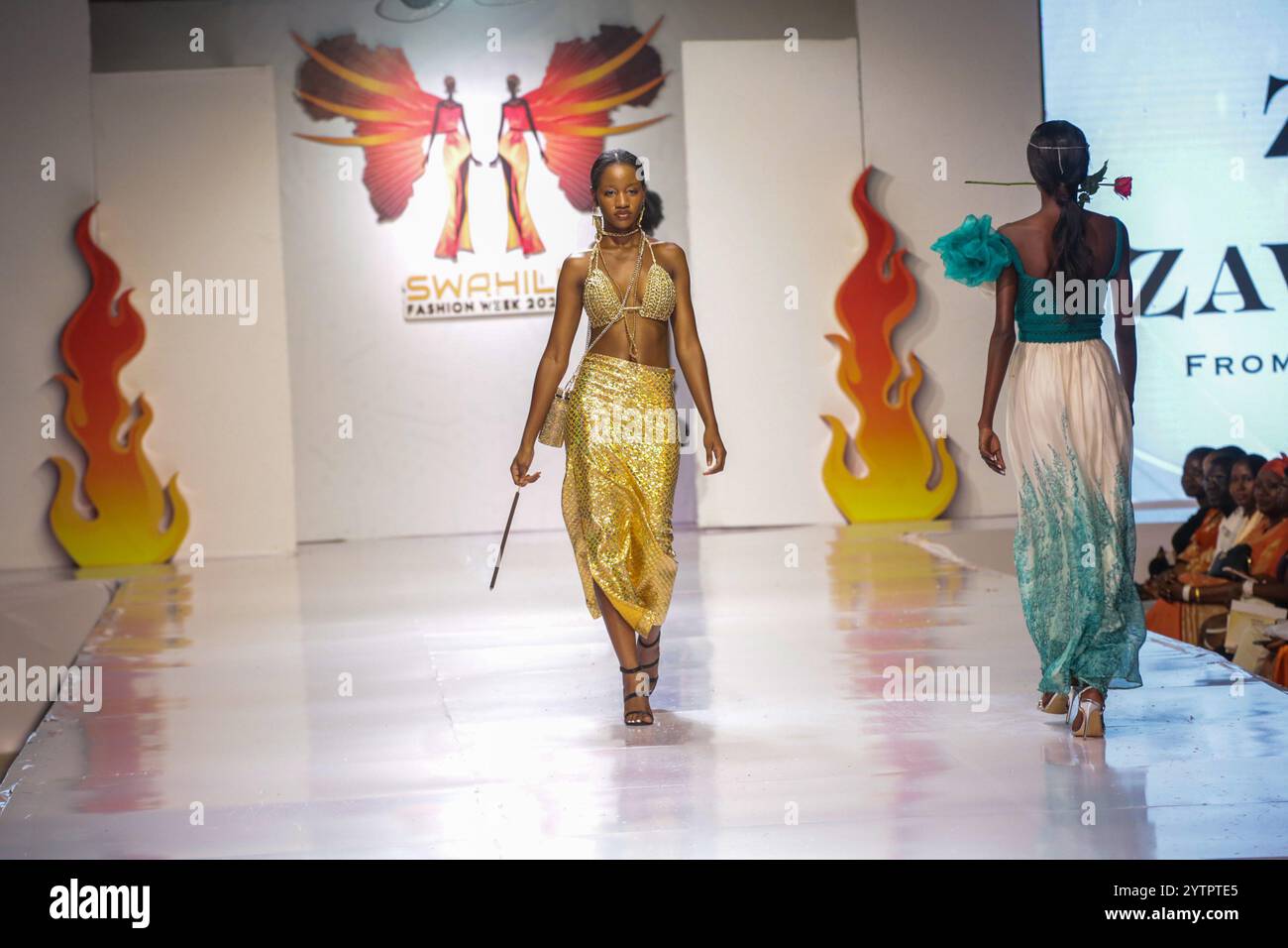 Dar Es Salaam, Tanzania. 6th Dec, 2024. Models present creations during ...