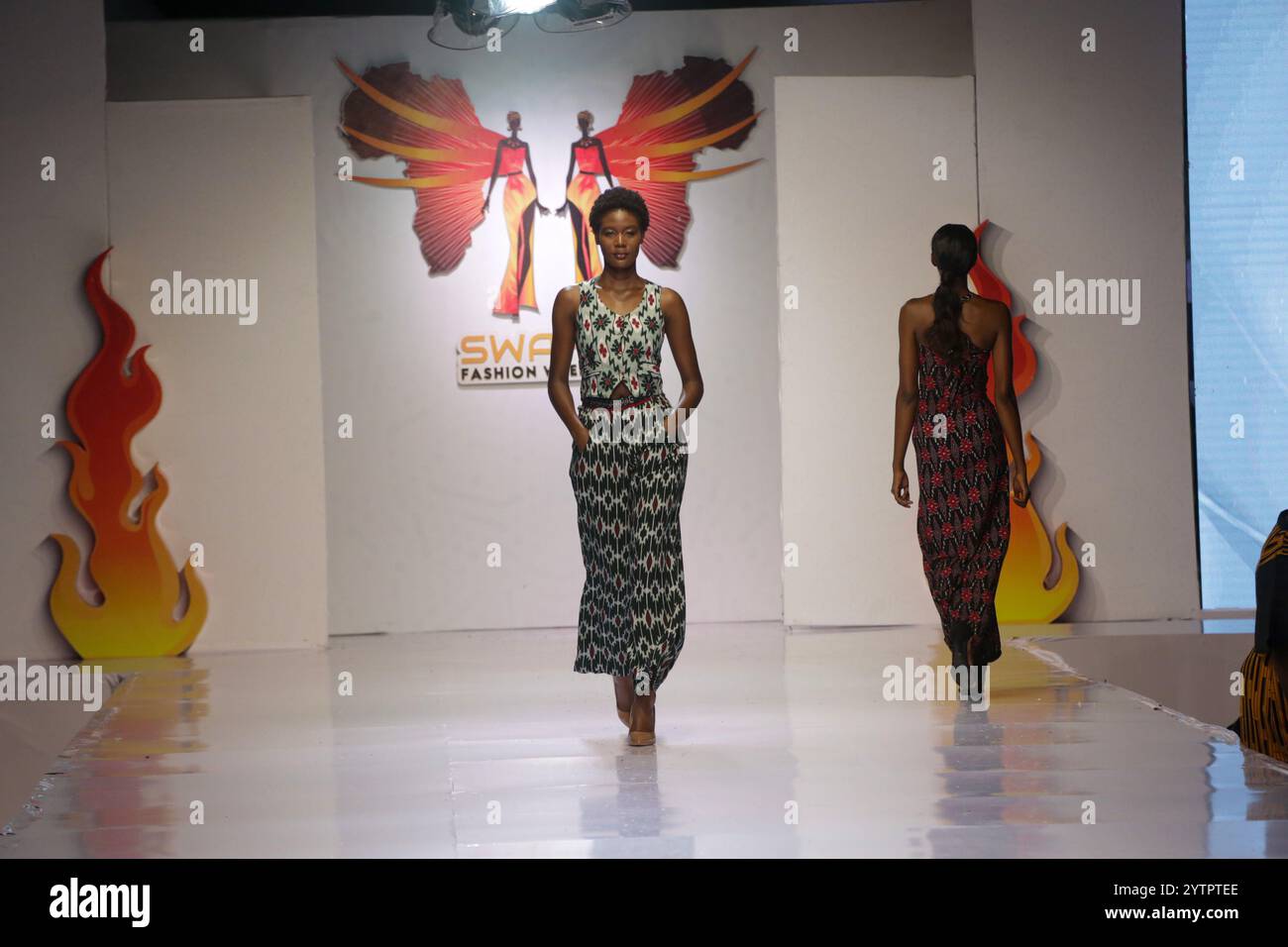 Dar Es Salaam, Tanzania. 6th Dec, 2024. Models present creations during ...