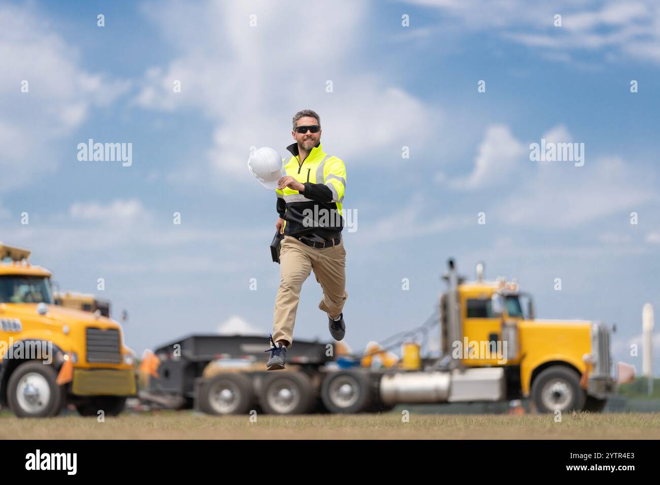 Engineer supervisor running outdoor. Supervisor jumping. Excited ...