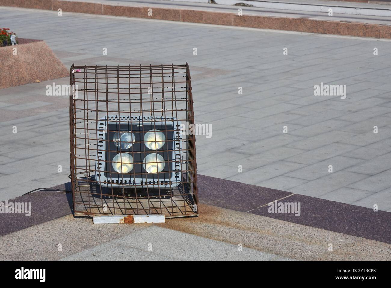 Floor street lamp in metal cage close up, vandalism protection ...