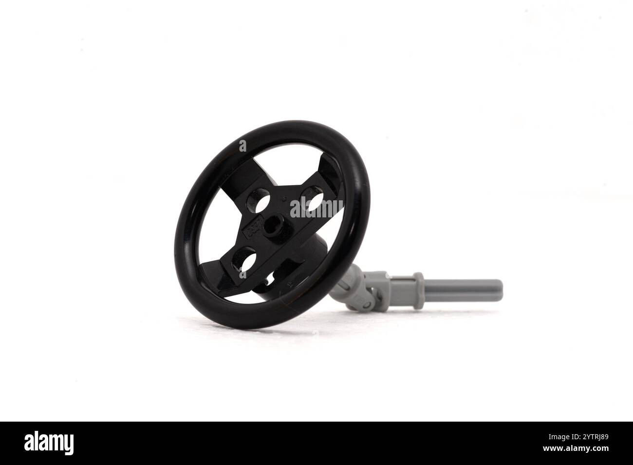 A black wheel with a silver shaft. The wheel is attached to a silver ...