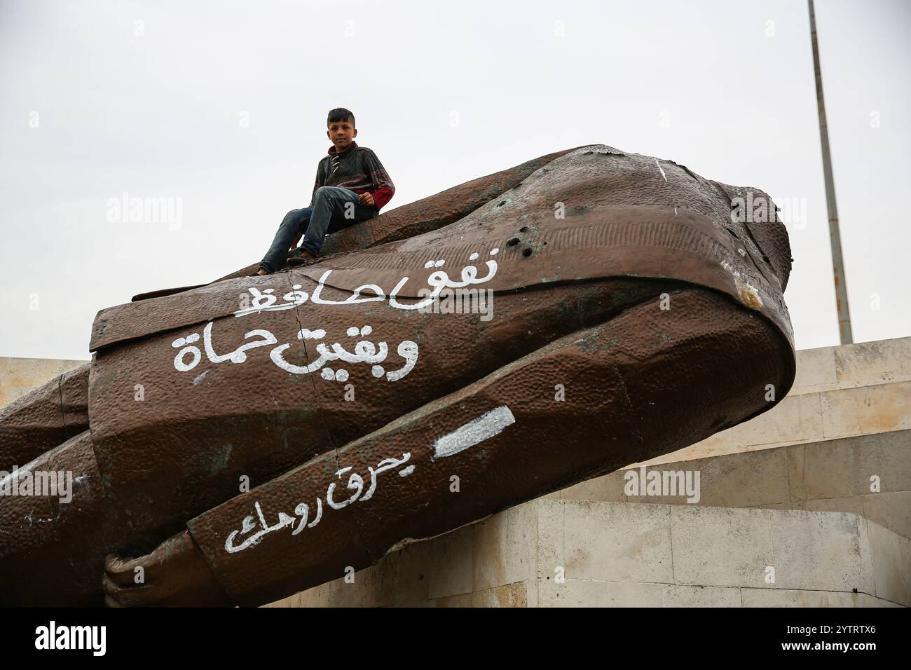 Hama, Syria. 07 December 2024. The torn down statue of former Syrian ...
