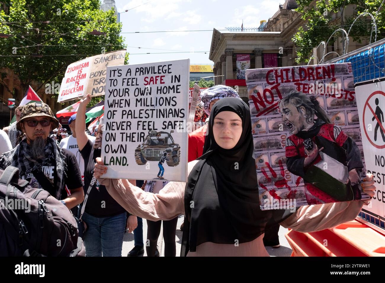 Demonstrators display placards at a pro Palestinian rally in Melbourne ...