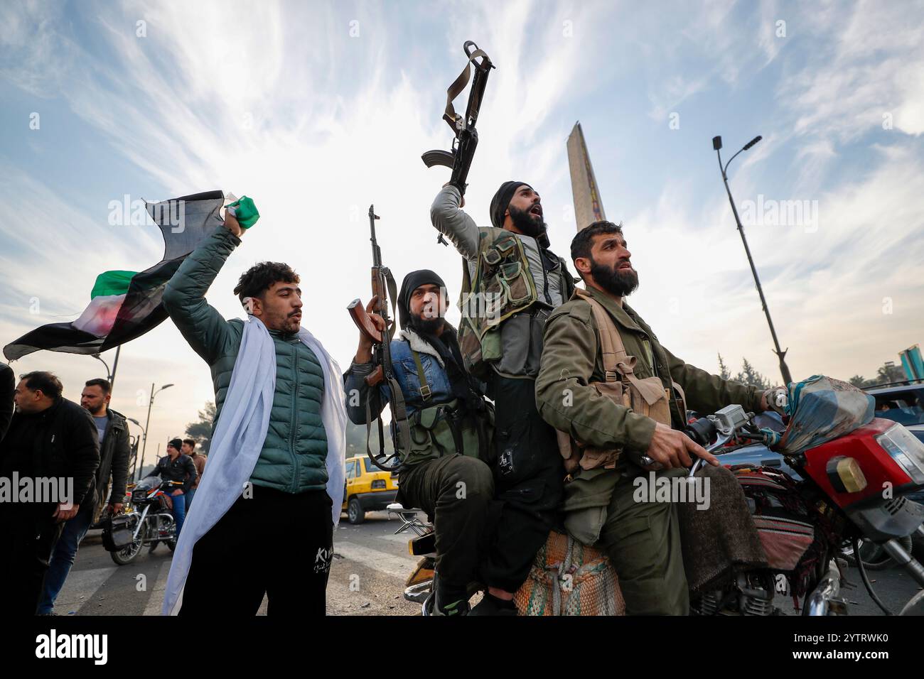 Syrian opposition fighters celebrate after the Syrian government ...