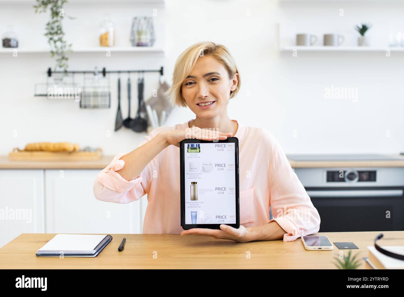 Happy Caucasian woman holding tablet displaying online cosmetics ...