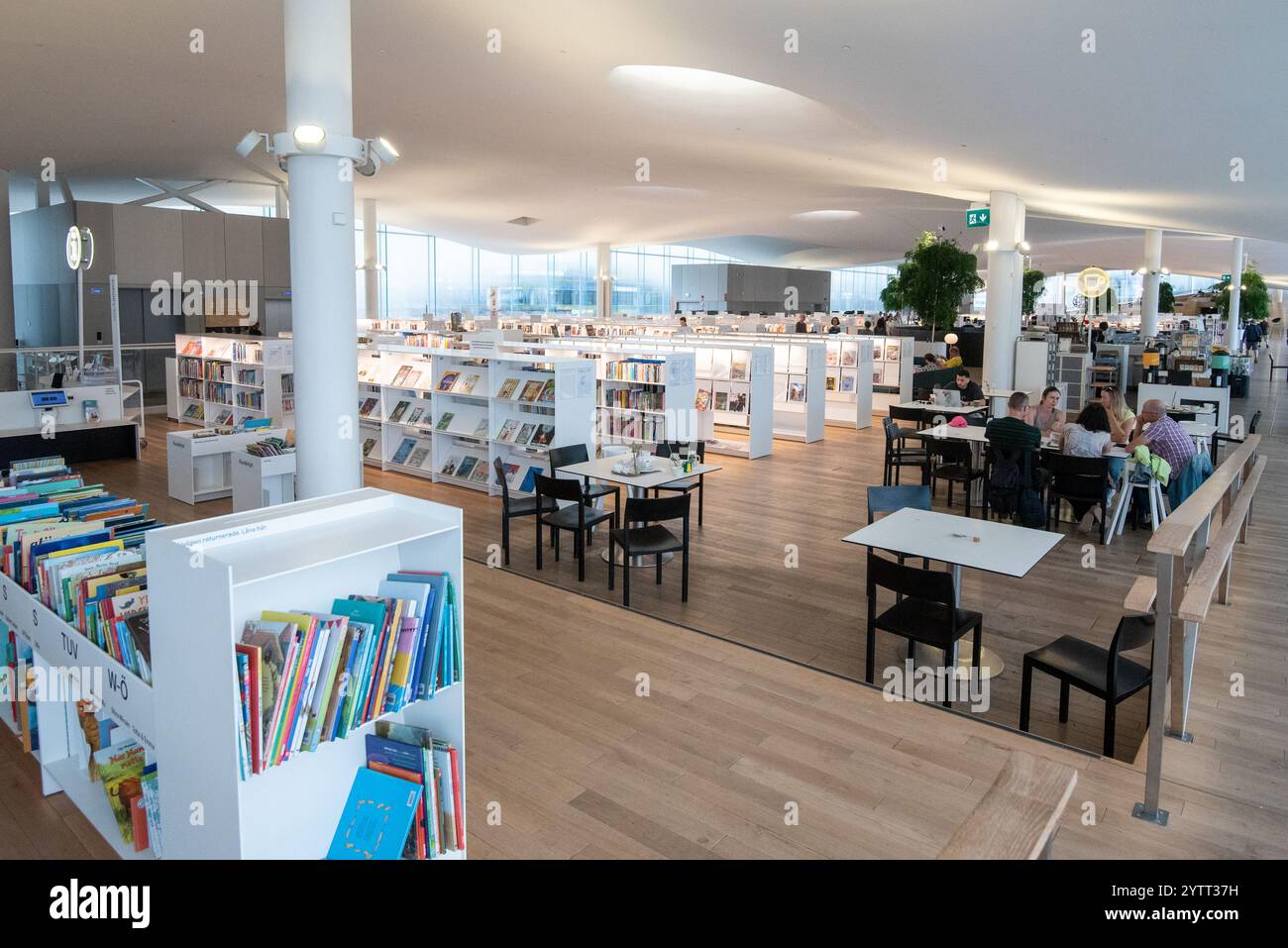 Modern library interior with visitors enjoying reading and studying ...