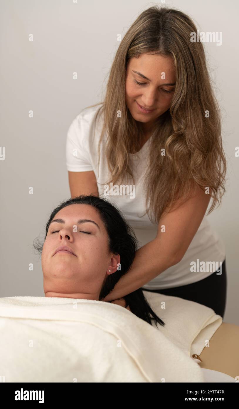 Beautiful woman in spa salon receiving head massage Stock Photo - Alamy