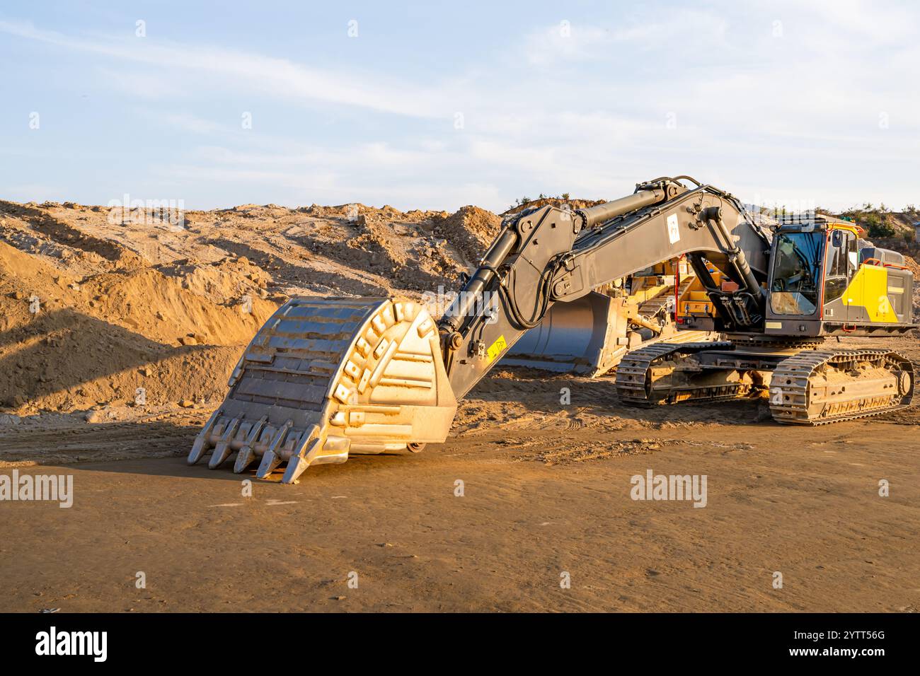 a backhoe parked at a work site after finishing work Stock Photo - Alamy