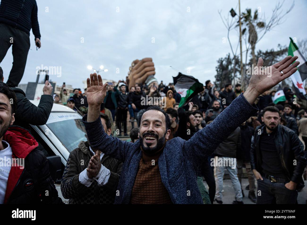 People gather to celebrate the fall of the Syrian government, in Manbij ...