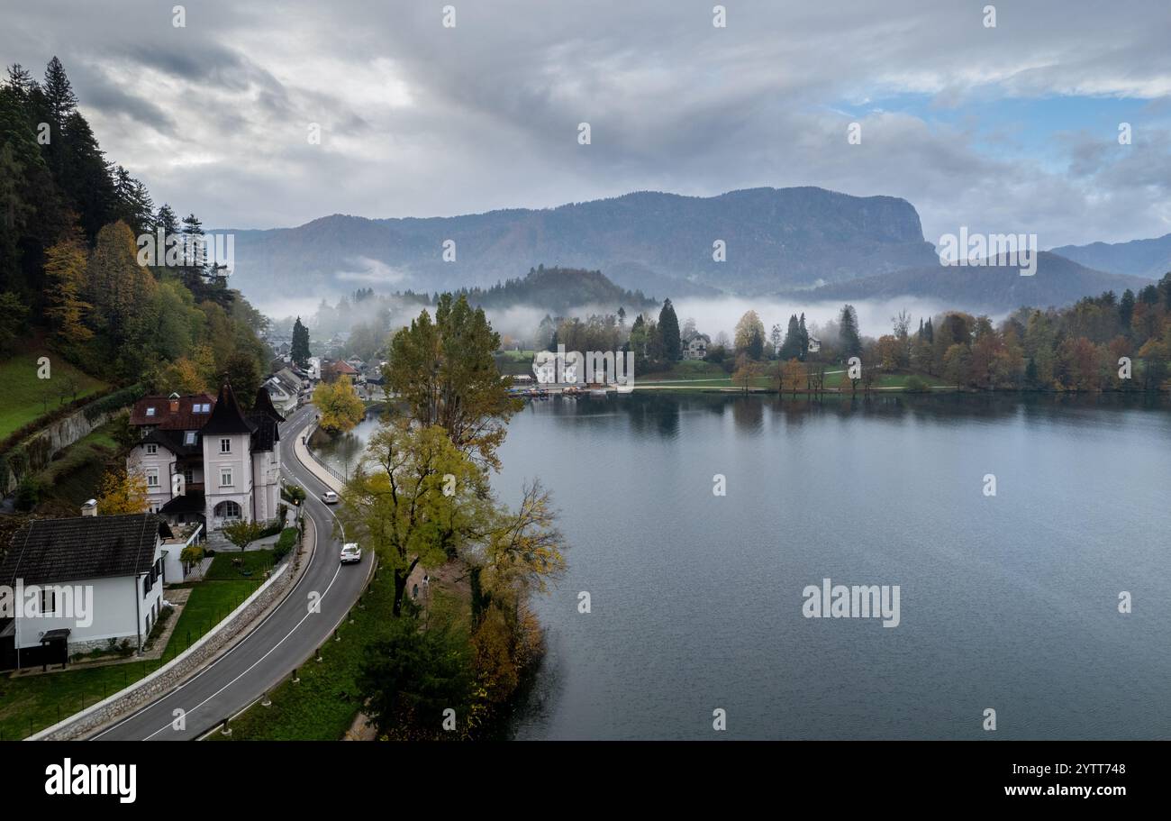 Aerial view of fog rolling over bled island on lake bled, slovenia ...